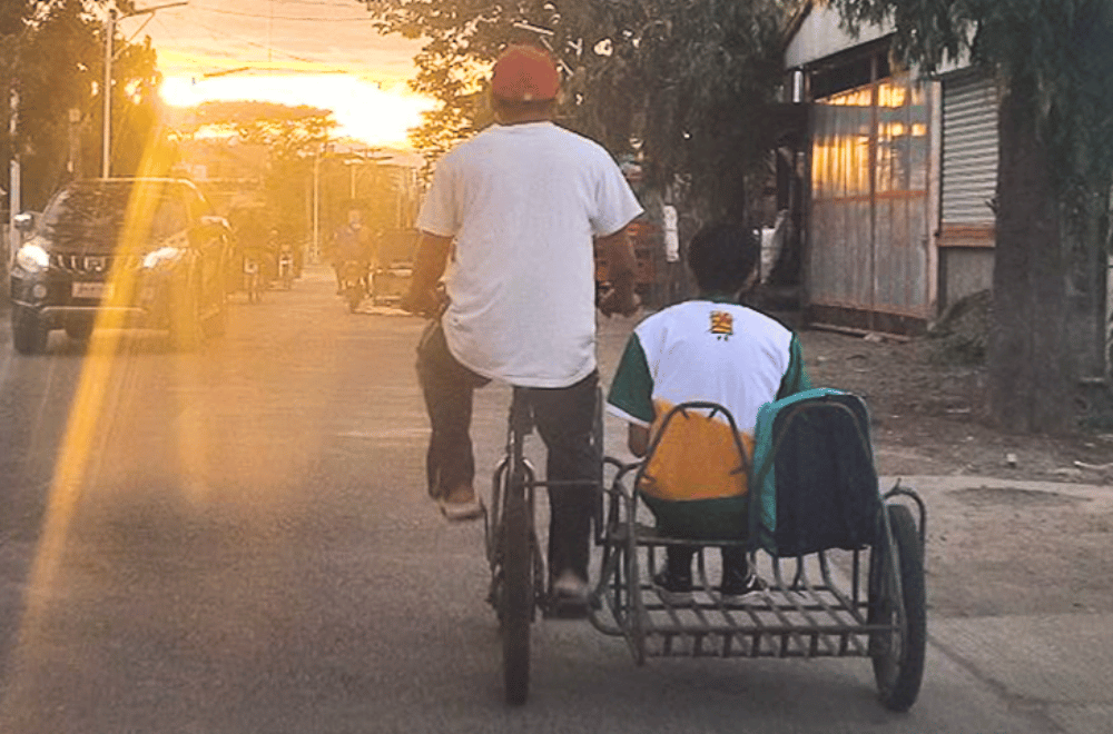 Student's daily bike ride with father inspires thousands