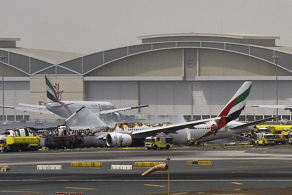 Emirates plane burns after crash landing in Dubai airport | Photos ...