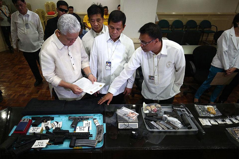 Cop yields high-powered firearms at NBI Las Piñas raid | Photos | GMA ...