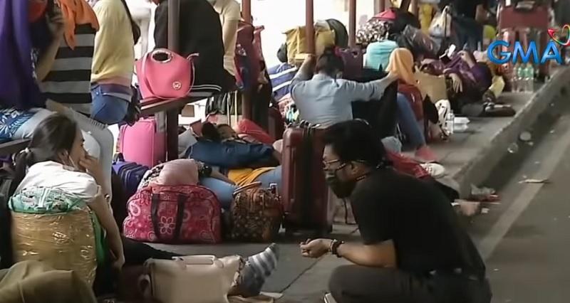 LSIs camp out at bus stop while awaiting flights home | GMA News Online