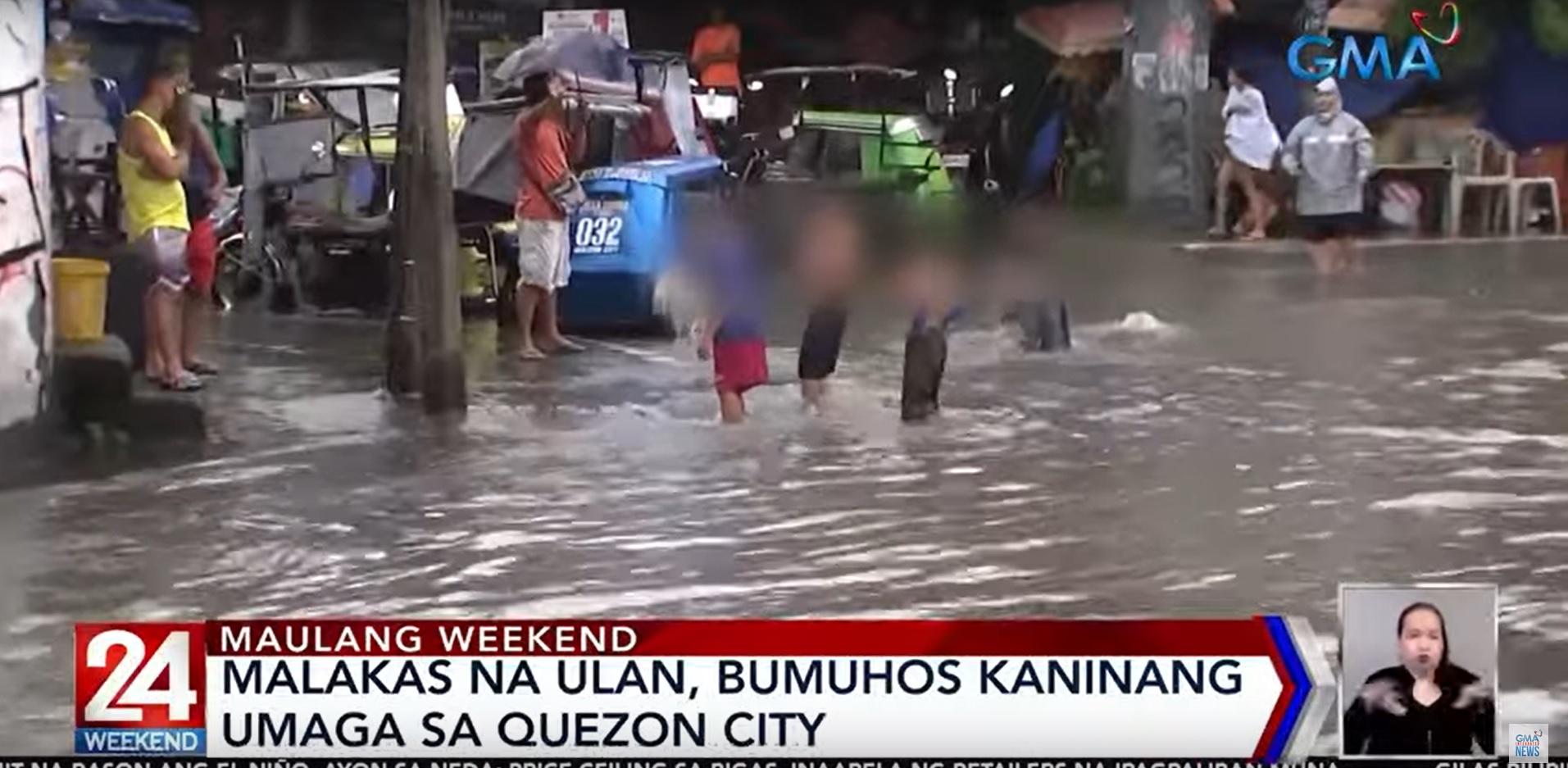 QC residents watch out for snakes along flooded street | GMA News Online