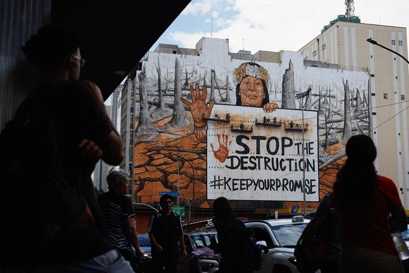 Brazilian artist and activist Mundano unveils a protest giant mural in ...